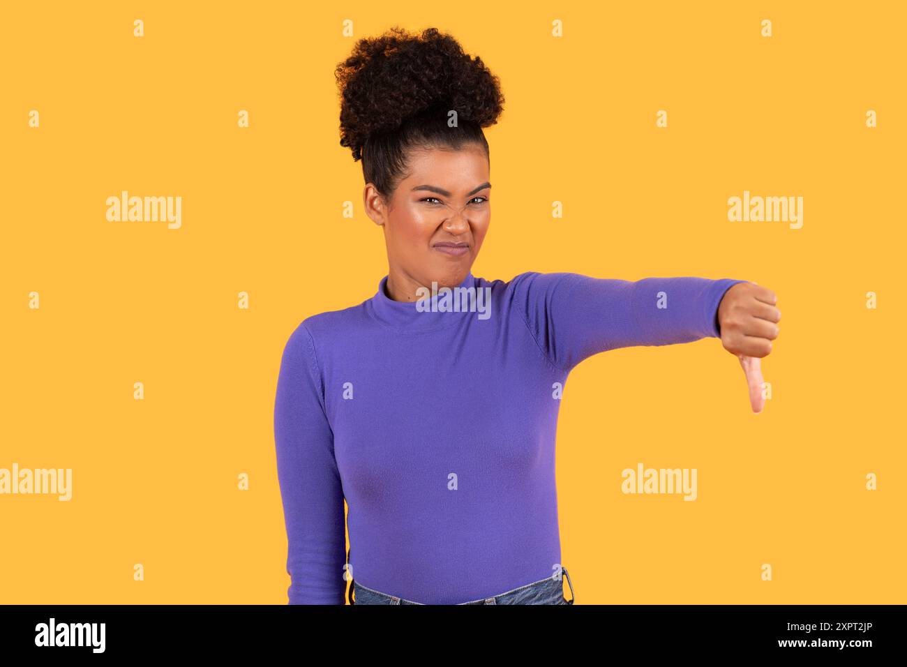 Young latin woman thumbs down hi-res stock photography and images - Alamy