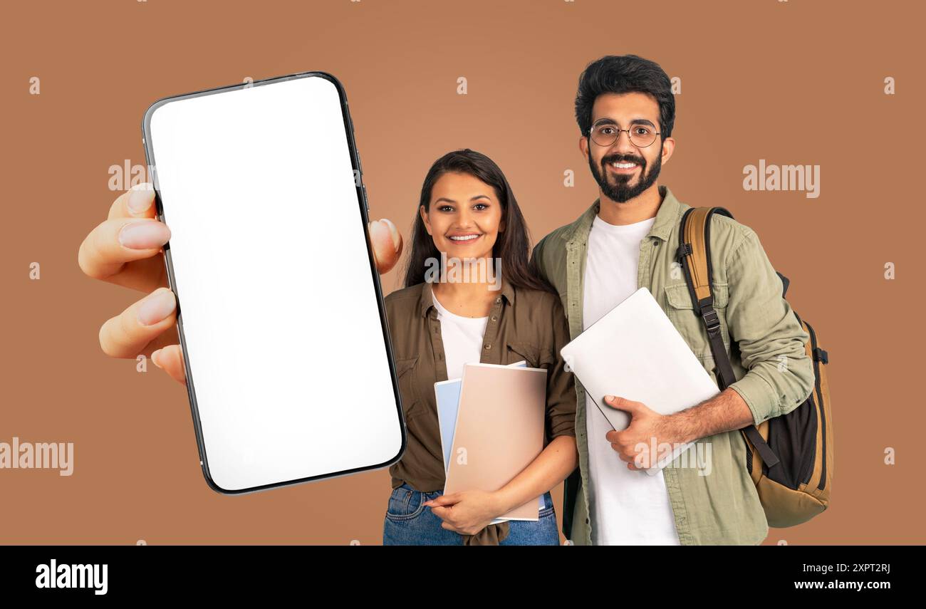 Smiling Students Holding Books and Smartphone With Blank Screen Stock ...