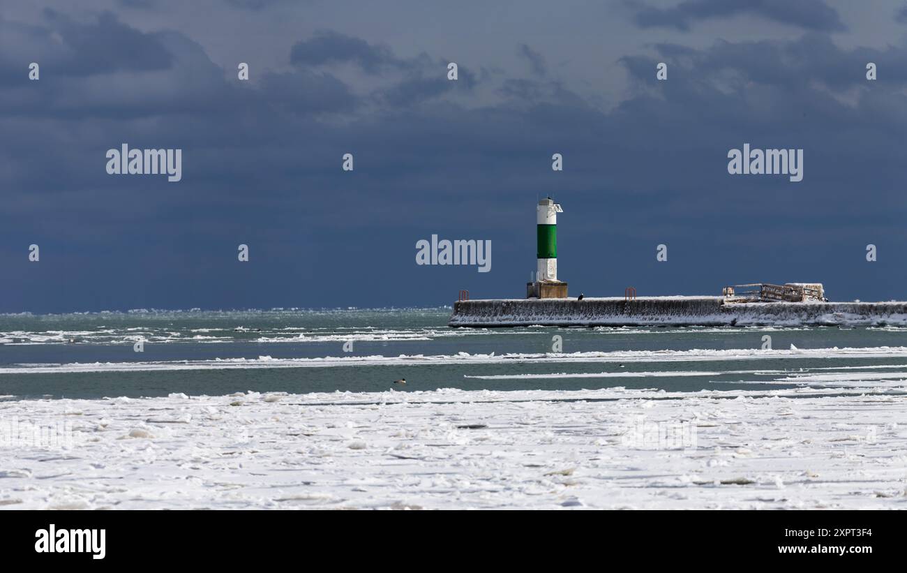 Lake Michigan Lighthouse and the frozen mouth of the Manitowoc River ...