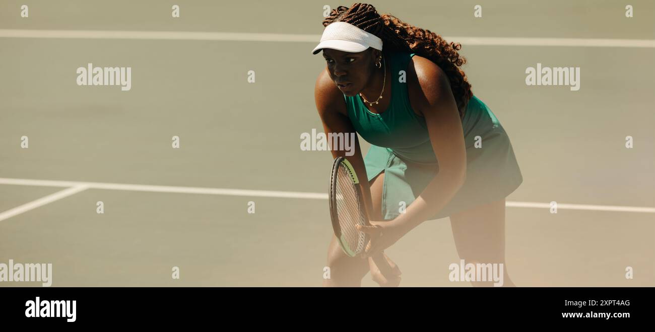 Focused woman playing tennis on a hardcourt with copy space. The image ...