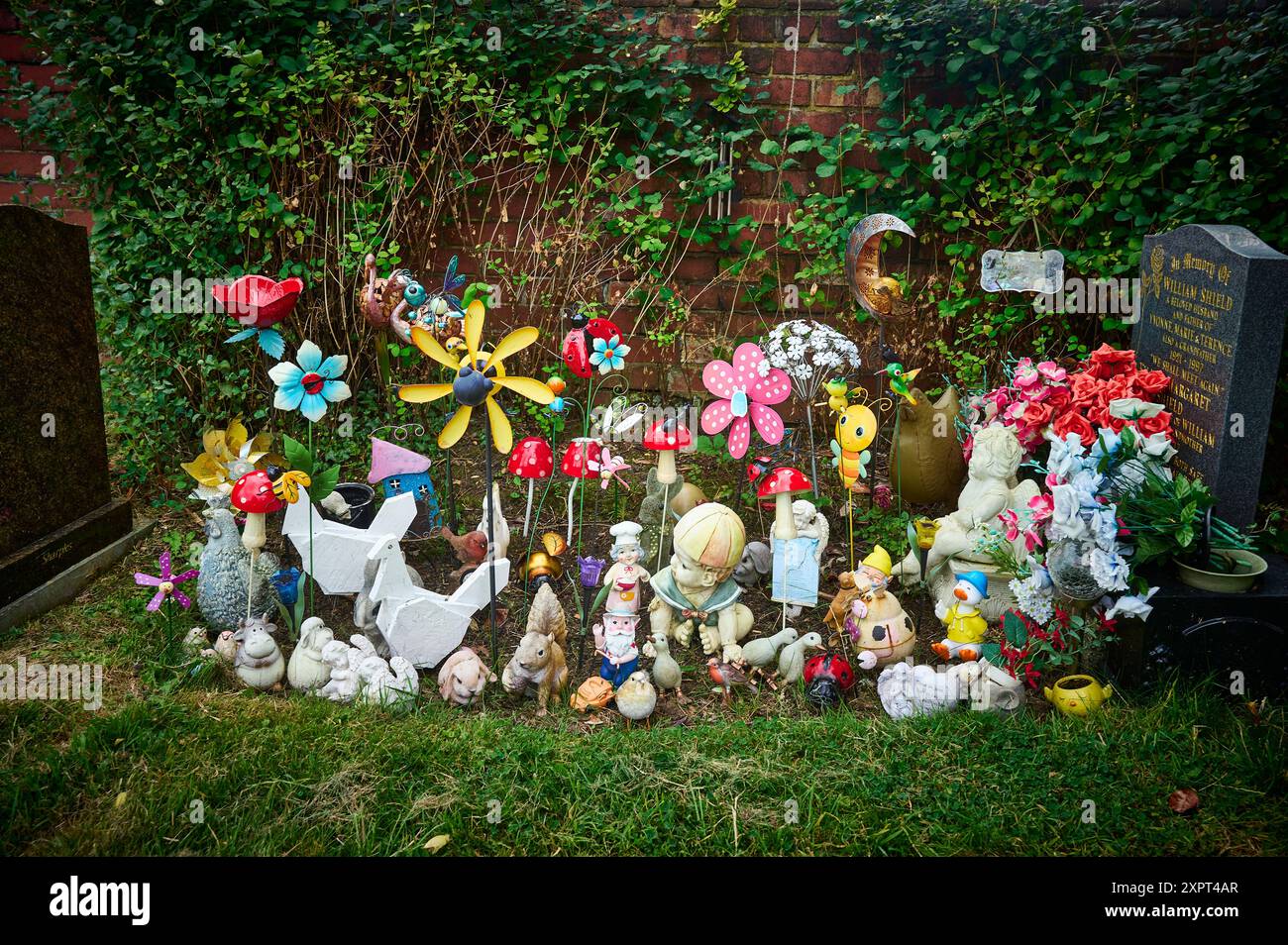 Colourful memorials on grave in Holy Trinity Church cemetery Stock ...