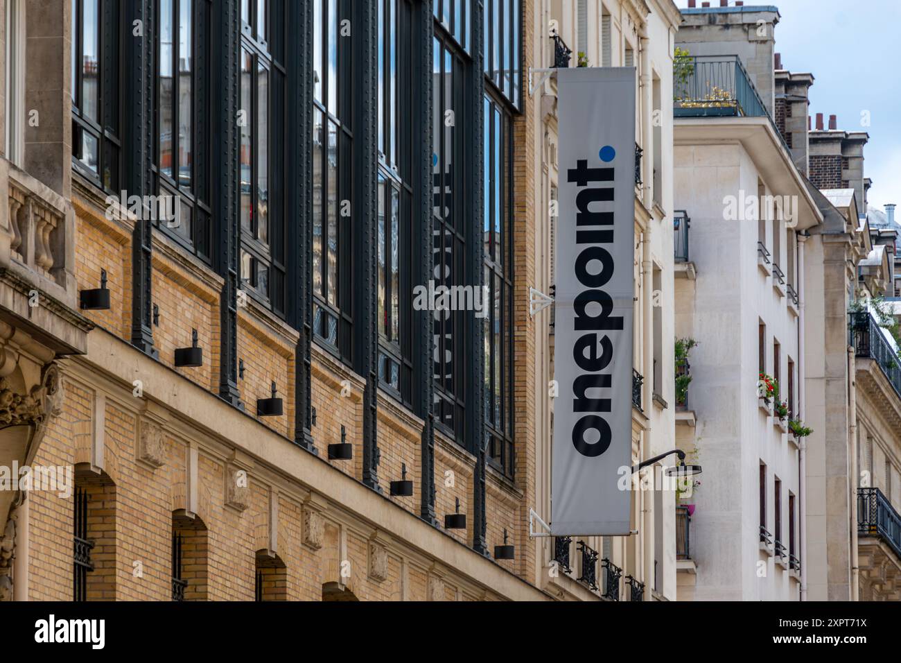Sign on the facade of the headquarters of Onepoint, a French consulting ...