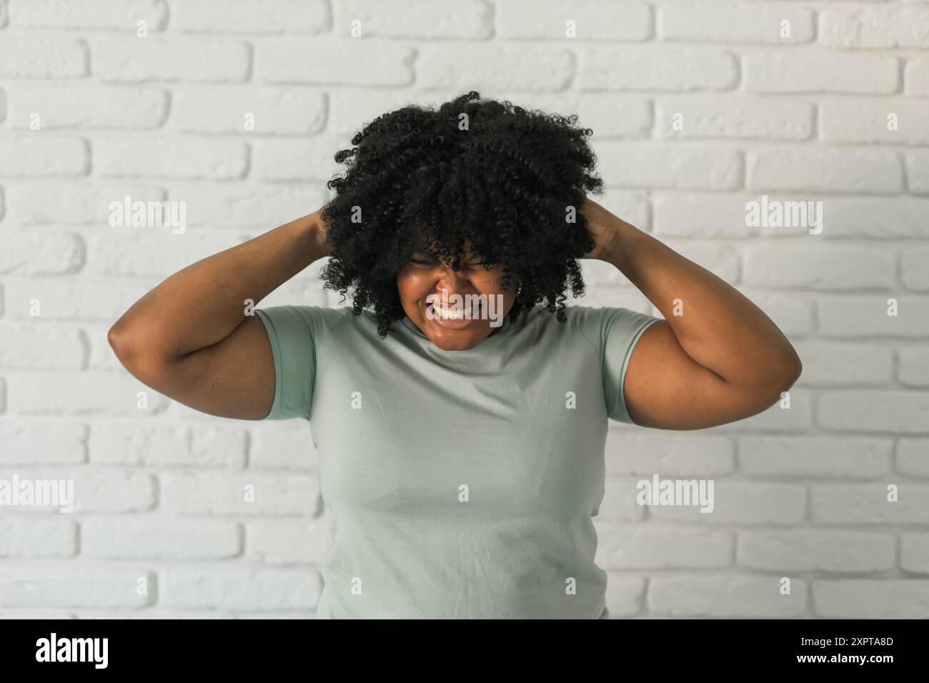 Angry millennial african american woman screaming on brick background ...