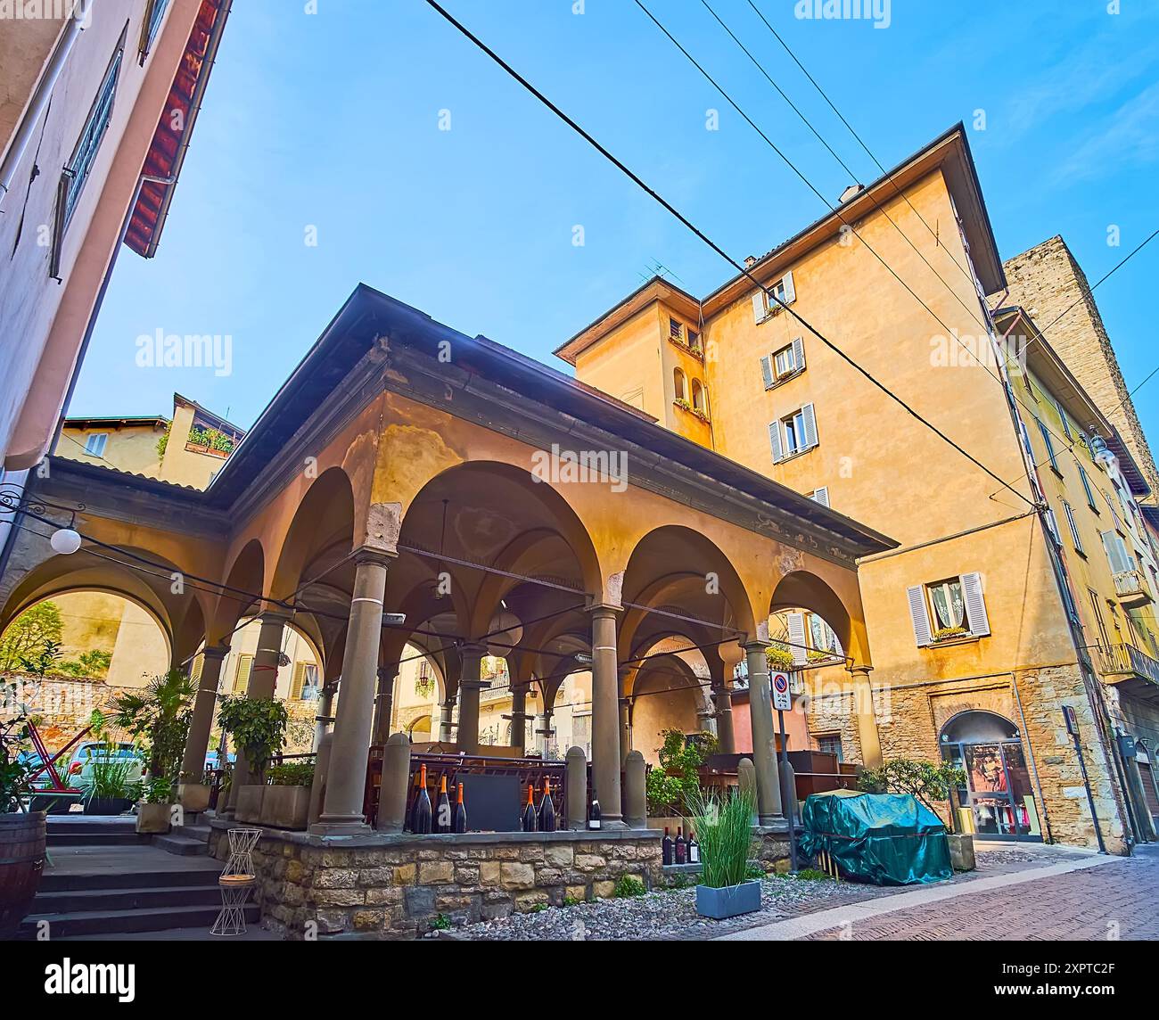 The medieval portico, occupied with tourist restaurant on Via Gombito ...