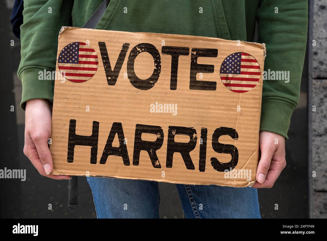 7 August 2024: Woman holding a handmade sign with the inscription: Vote ...