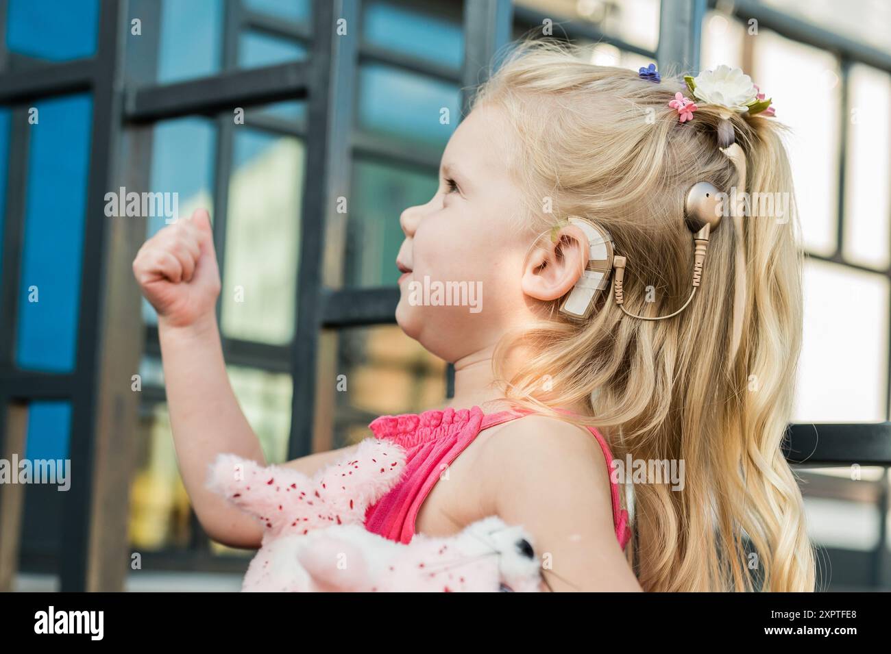 Child walks with cochlear implant system. Installation cochlear implant ...