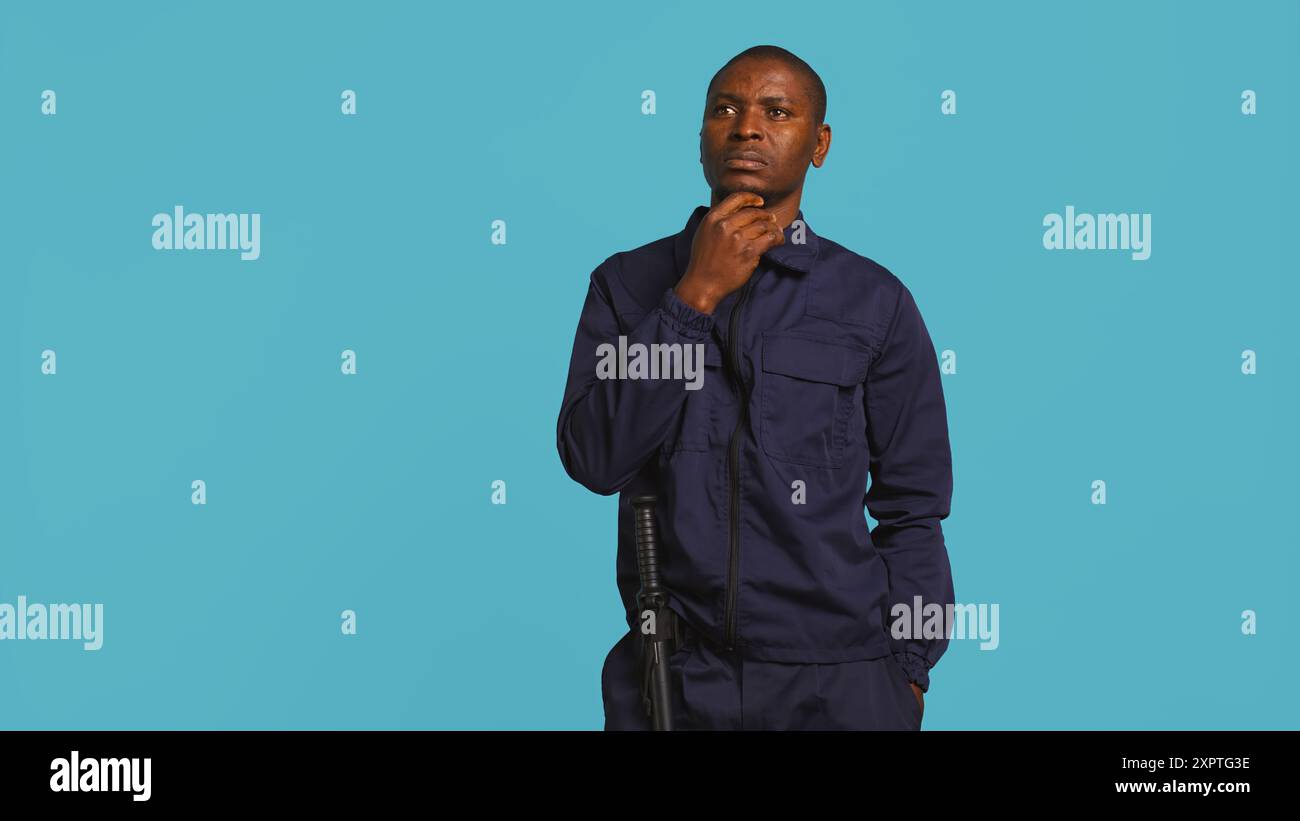 Security guard doing thinking hand gesture during surveillance shift ...