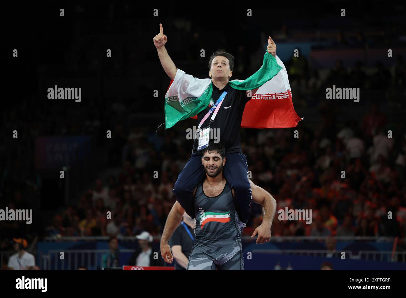 Iran's SARAVI Mohammadhadi with his coach celebrates after winning the ...