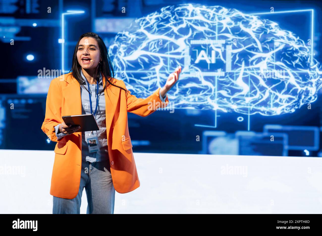 Cheerful manager holding tablet speaking at event bringing together leading researchers to ...