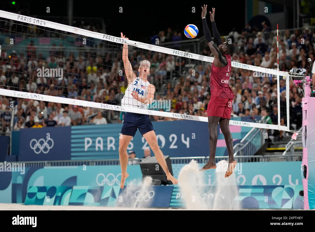 Qatar's Cherif Younousse goes up for the block against United State's ...