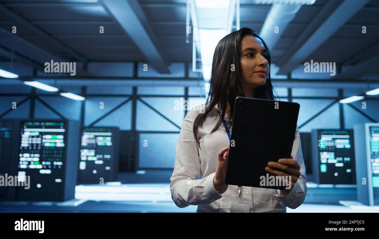 Admin In Data Center Monitoring Security Threats With Tablet