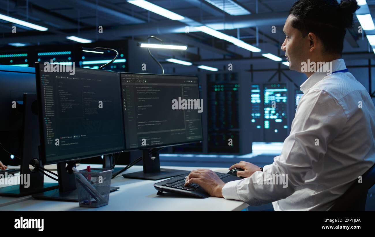 Engineer overseeing data center, making routine improvements and ...