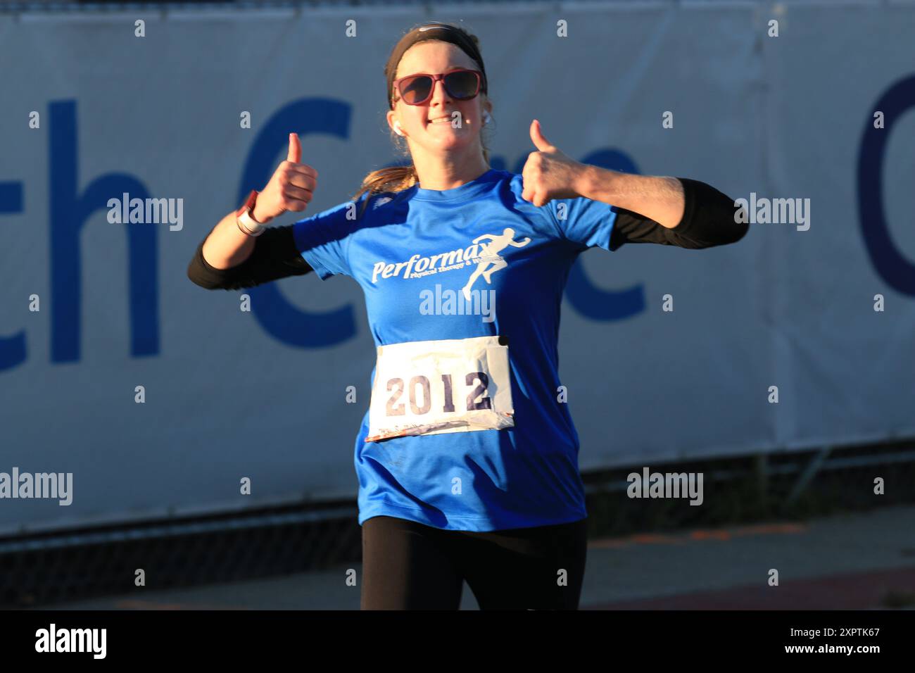 West Islip, New York, USA - 22 October 2023: One Female Runner giving ...