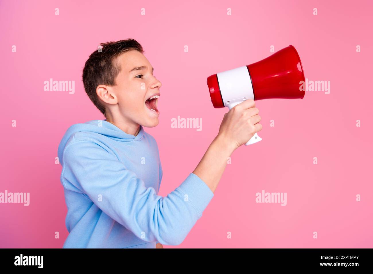 Photo portrait of charming teen boy megaphone scream empty space ...