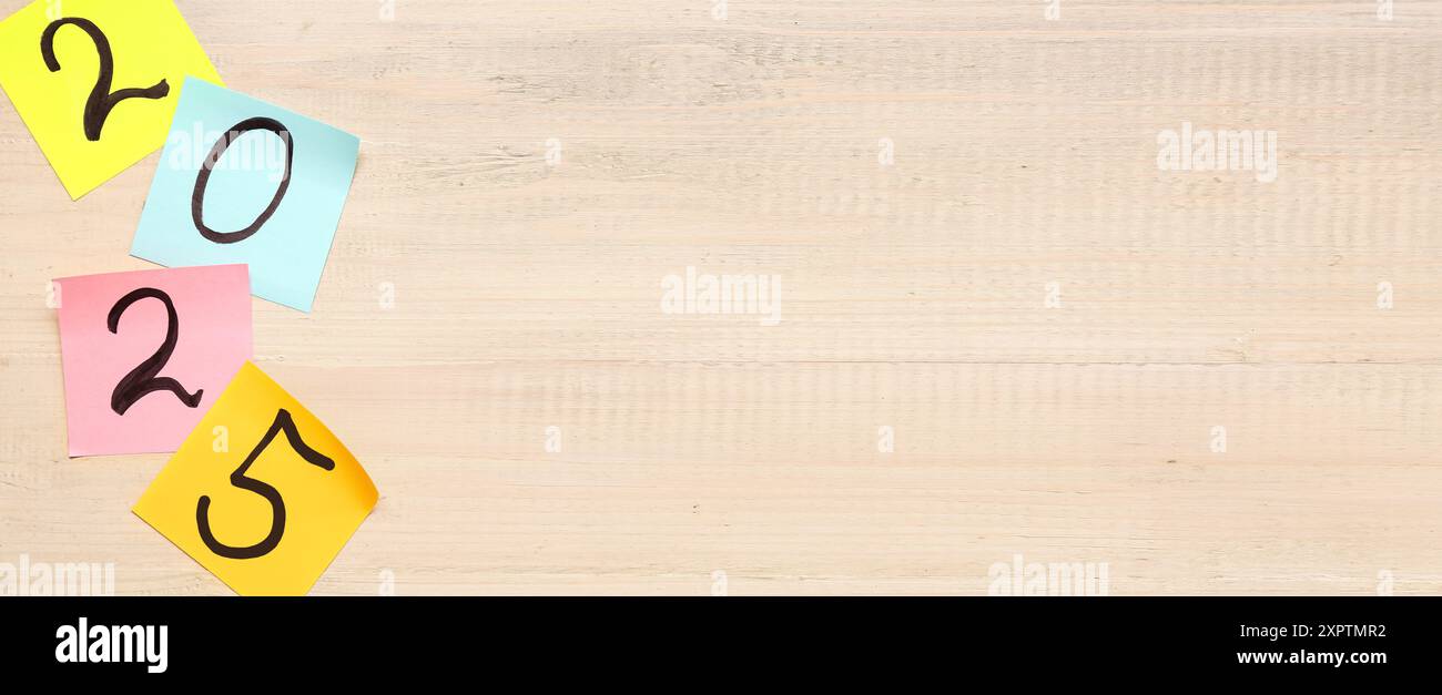 Figure 2025 made of sticky notes on wooden background with space for ...