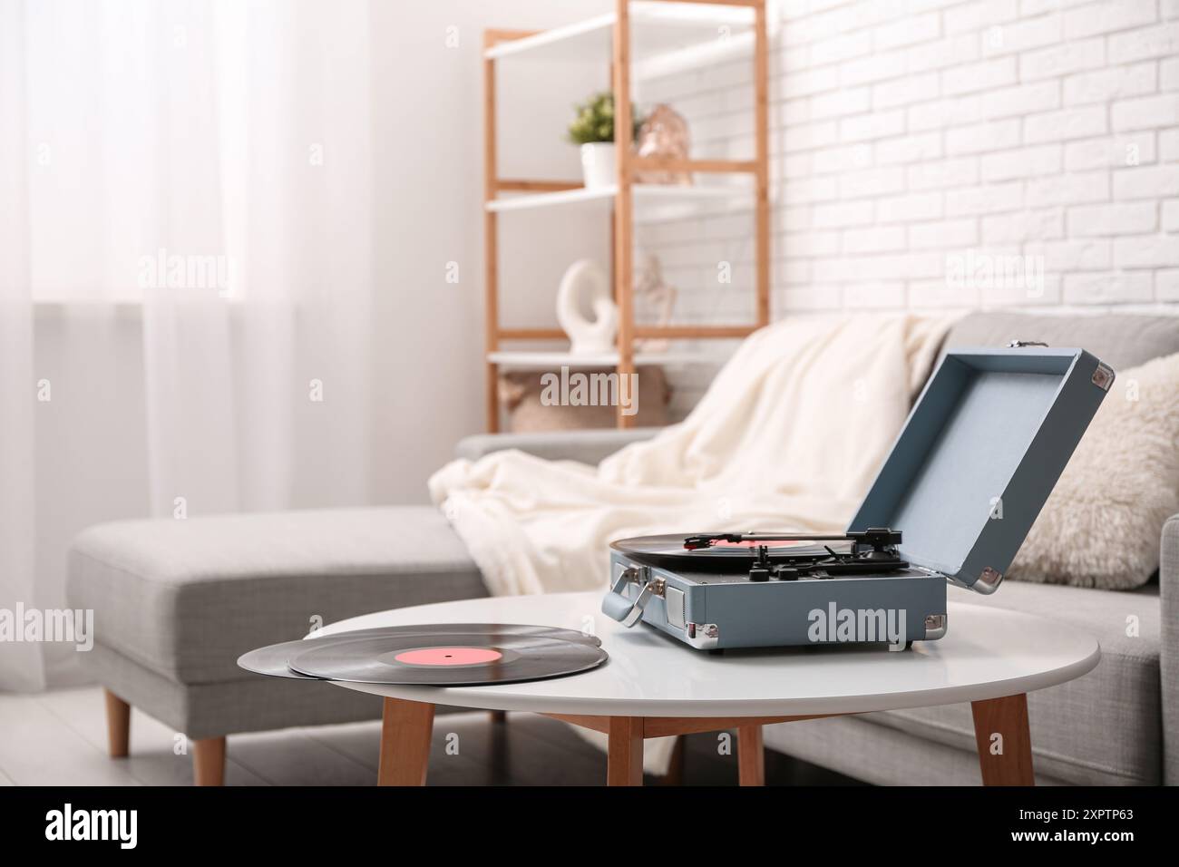 Interior of living room with sofa and record player on coffee table ...
