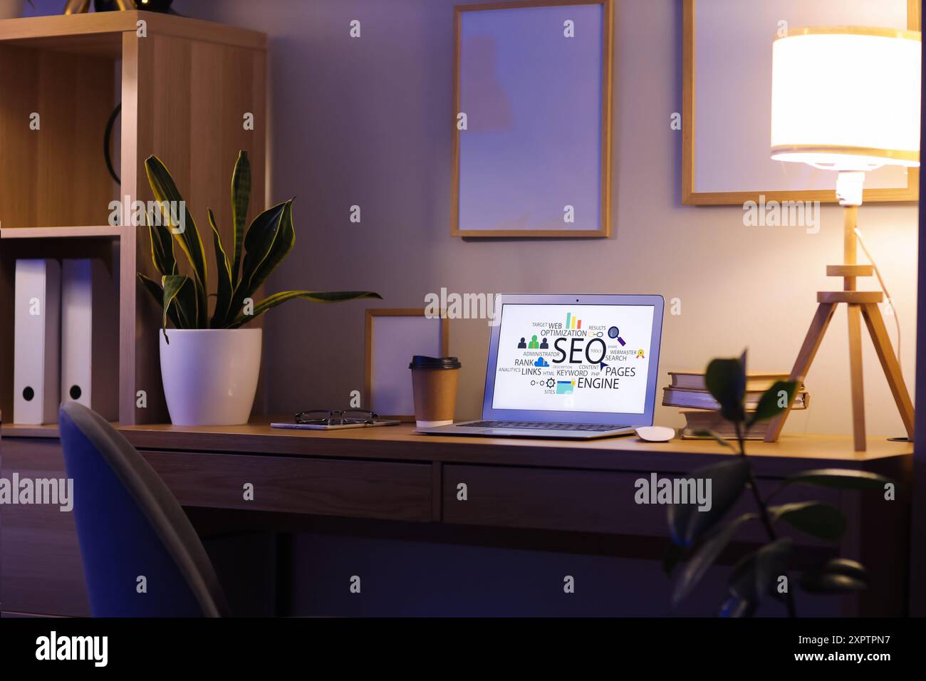 Laptop with abbreviation SEO on desk in dark office Stock Photo - Alamy
