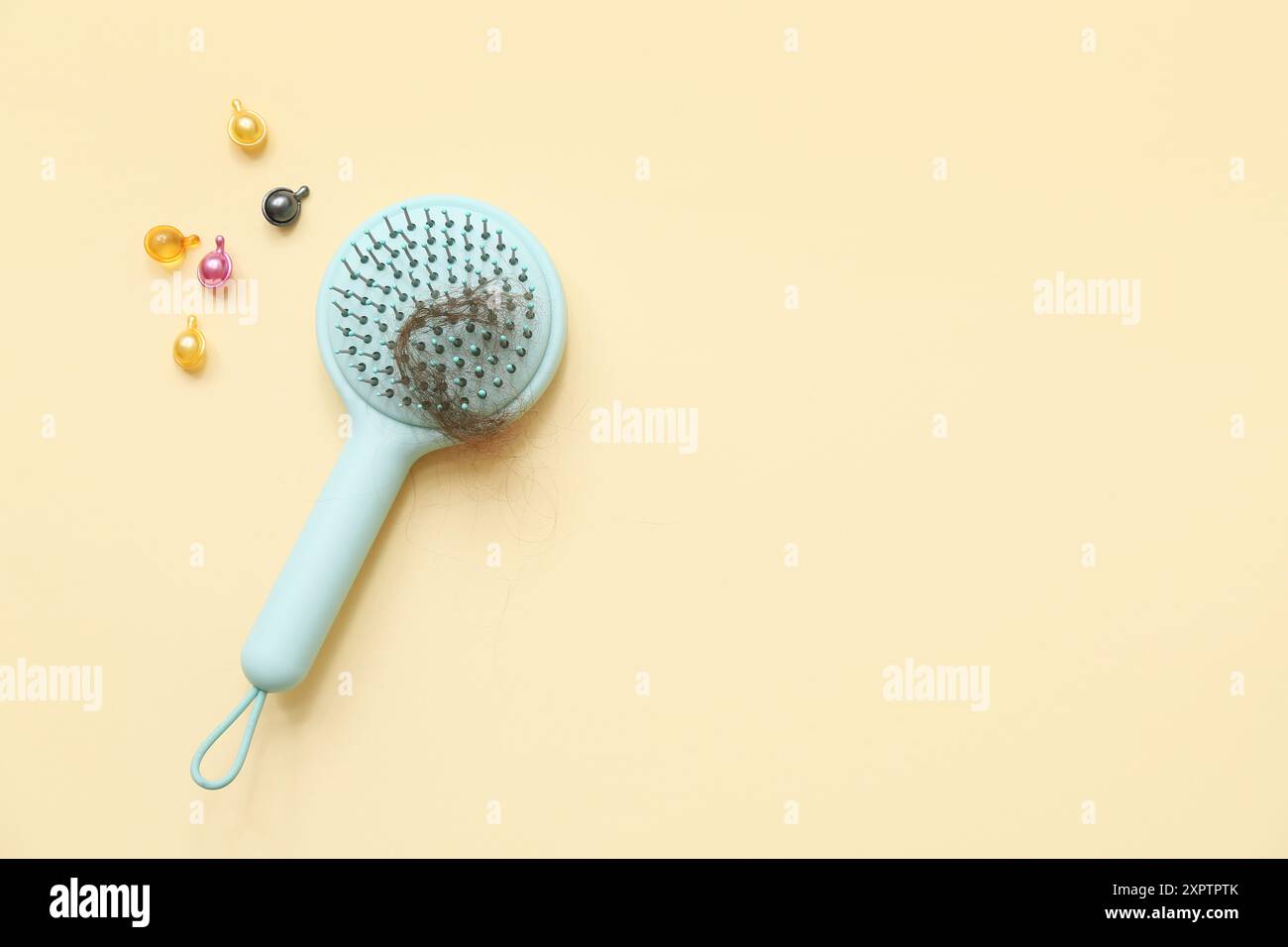 Brush, capsules and clump of hair on beige background. Hair loss ...