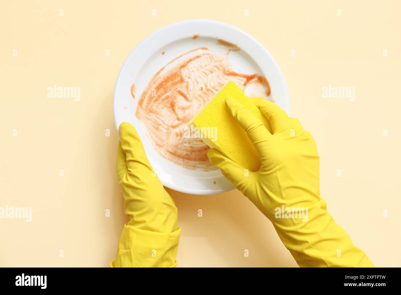 Hands washing dishes on beige background Stock Photo - Alamy