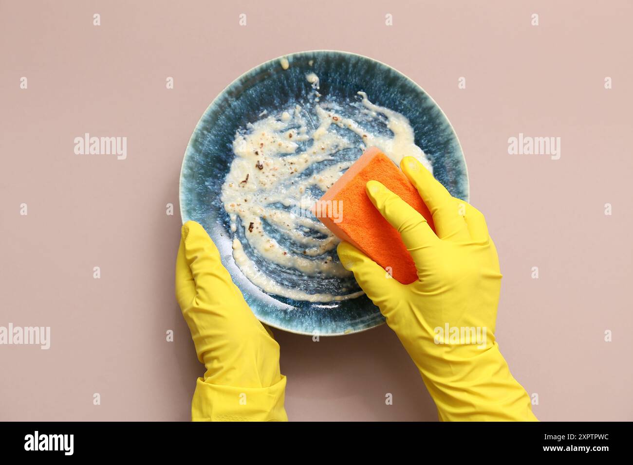 Hands washing dishes on beige background Stock Photo - Alamy