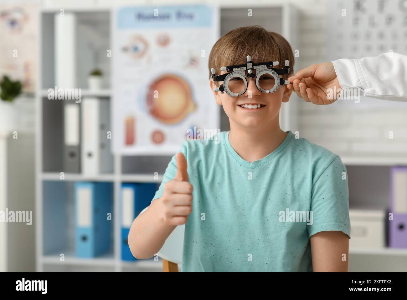 Ophthalmologist examining little boy eyes in clinic Stock Photo - Alamy