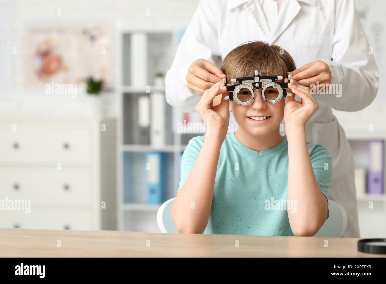 Ophthalmologist examining little boy in clinic Stock Photo - Alamy
