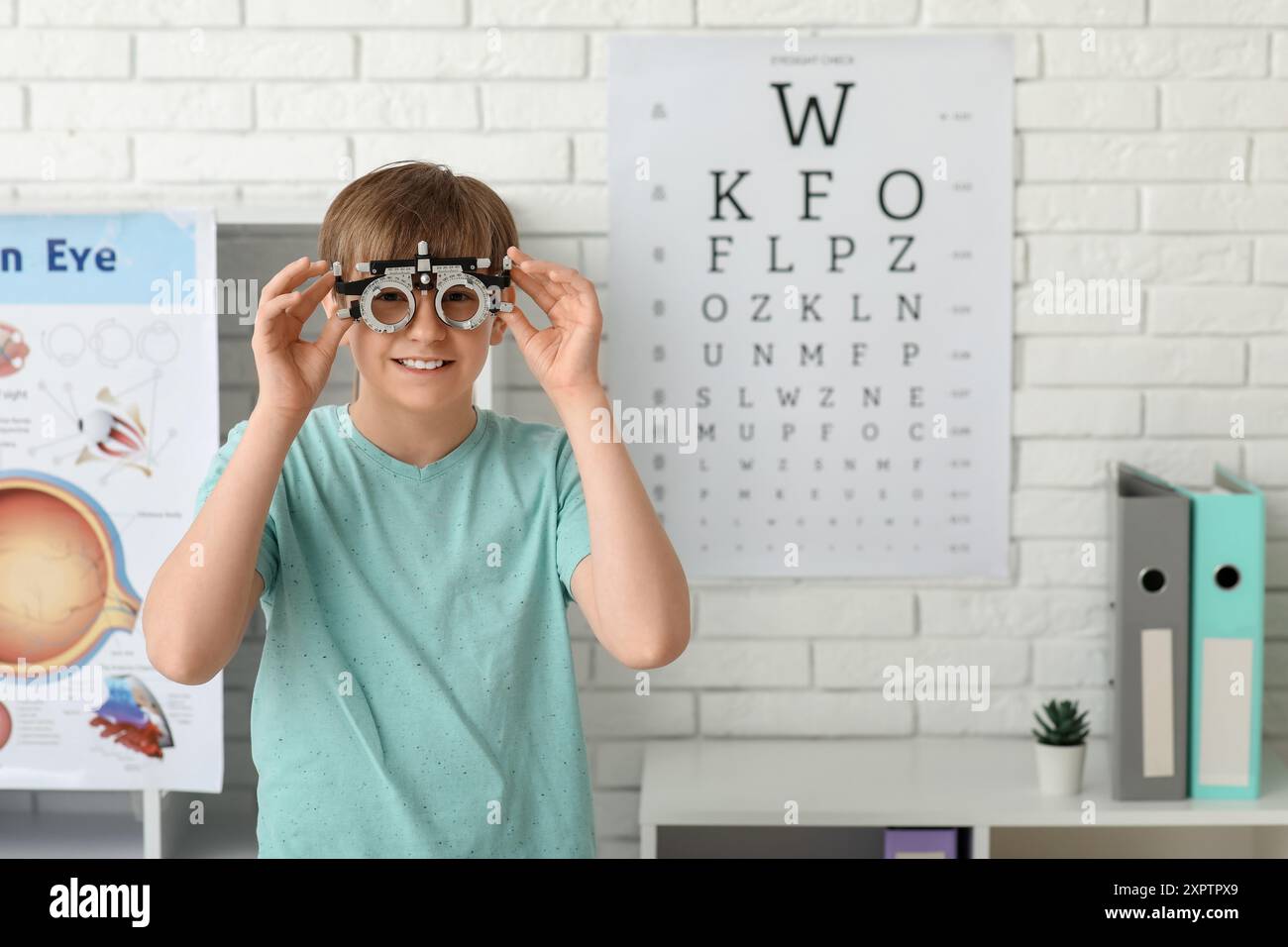 Little boy undergoing eye test in light clinic Stock Photo - Alamy