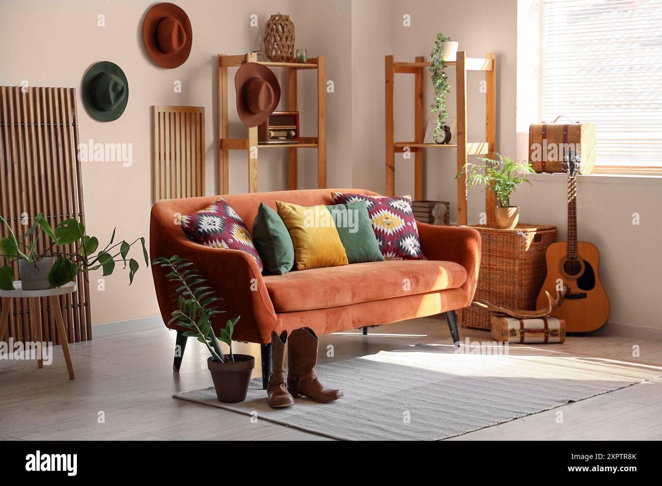 Interior of living room with sofa, cowboy hats and boots Stock Photo ...