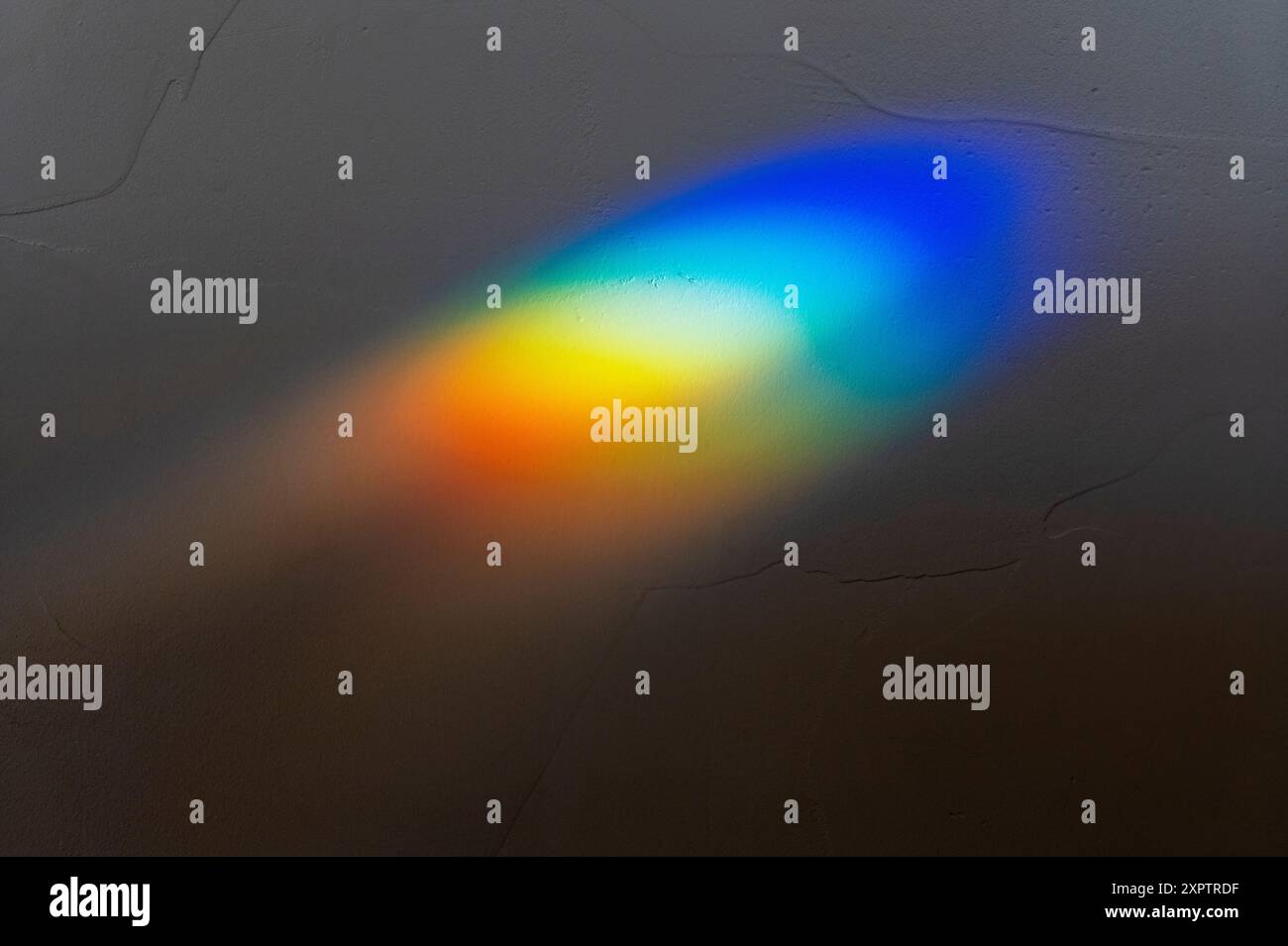 Refracted sunlight through stained glass window creates a prism of ...