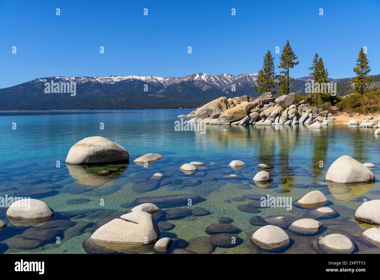 Rocky Blue Lake - A calm Spring day view of a crystal-clear rocky cove ...
