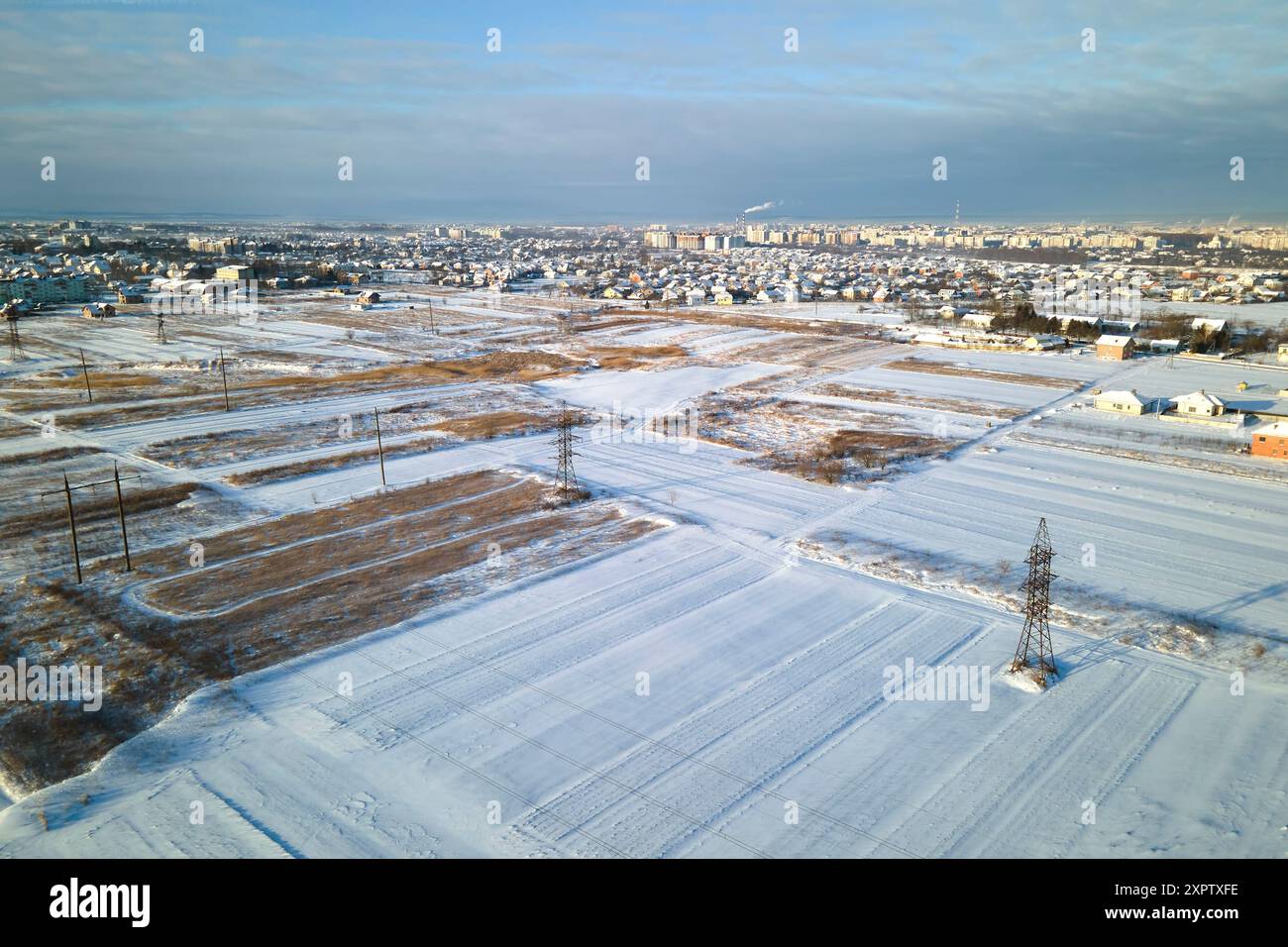 Aerial view of snow covered agricultural fields with barren surface in ...