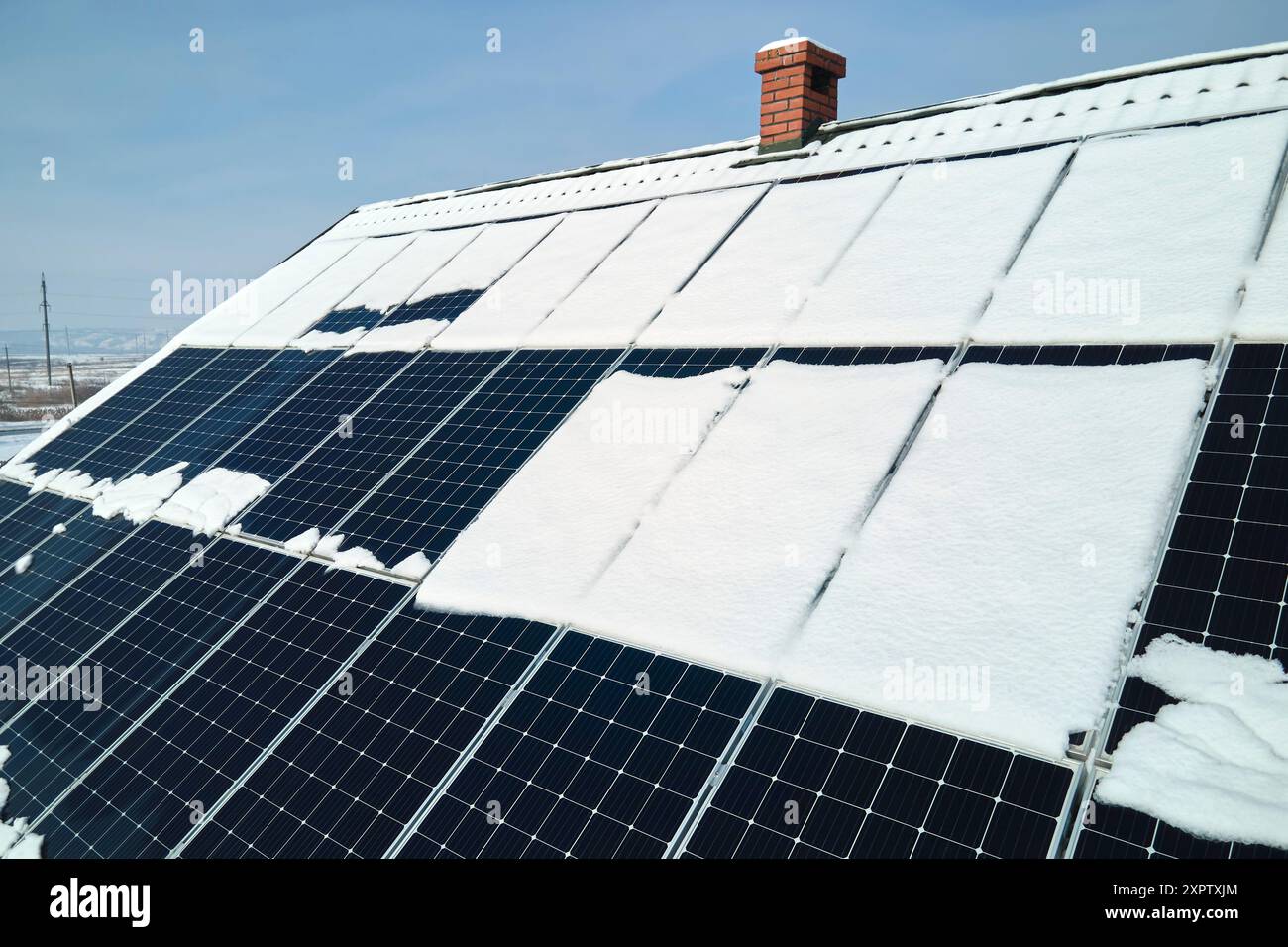 Aerial view of snow melting from covered solar photovoltaic panels ...