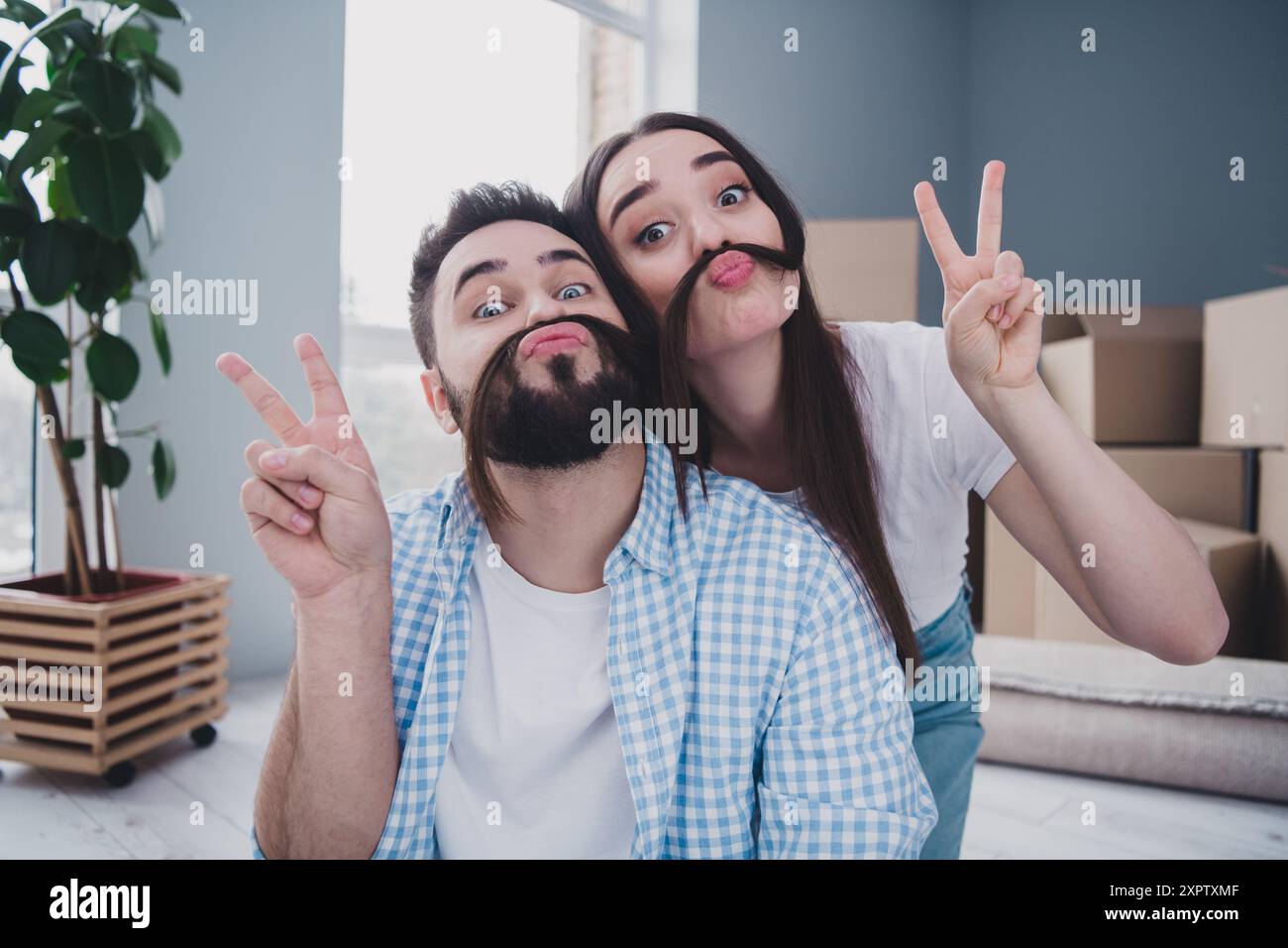 Portrait of two young people show v-sign hair mustache relocating ...