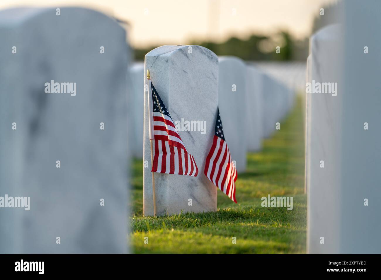 Army veteran cemetery with white headstones and USA flag. Tombs of ...