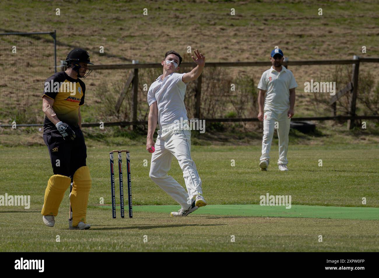 Bowler delivering the ball in a game of Cricket Stock Photo - Alamy