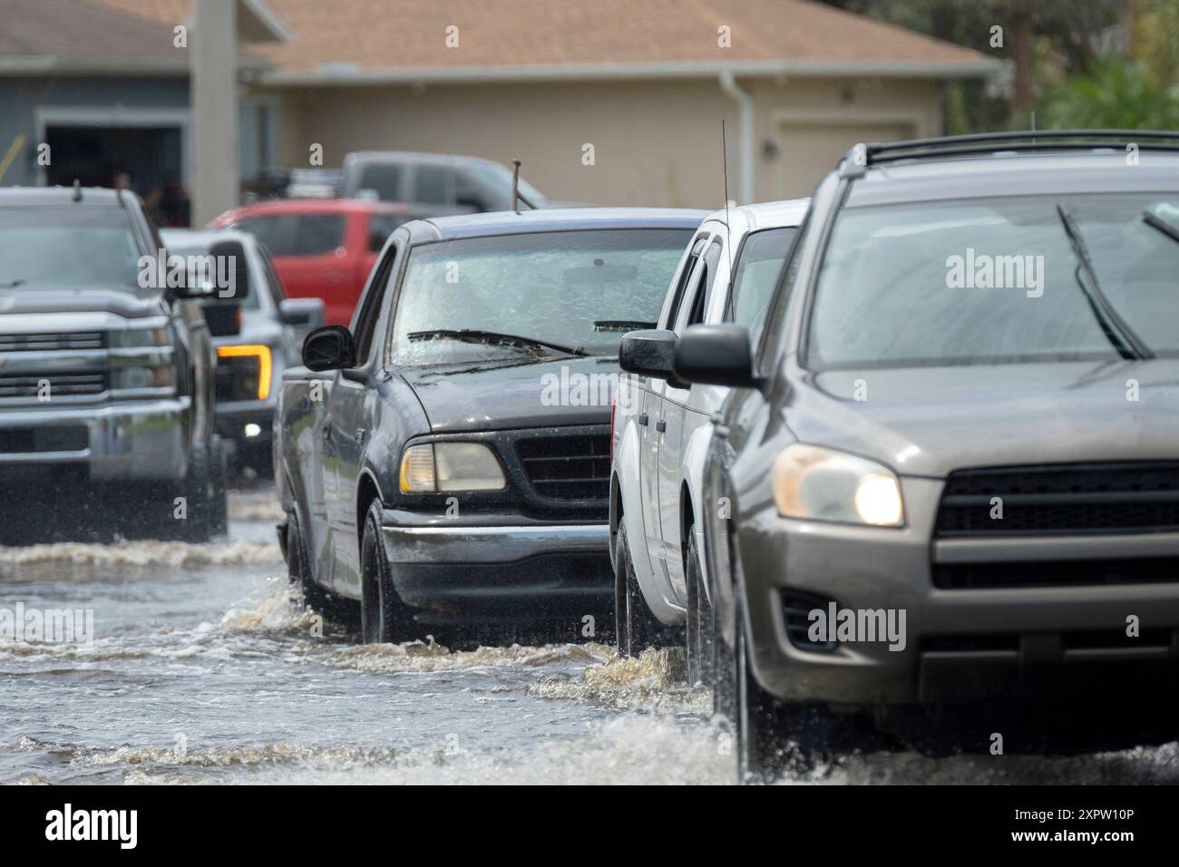 Flooded street after hurricane rainfall with driving cars in Florida ...