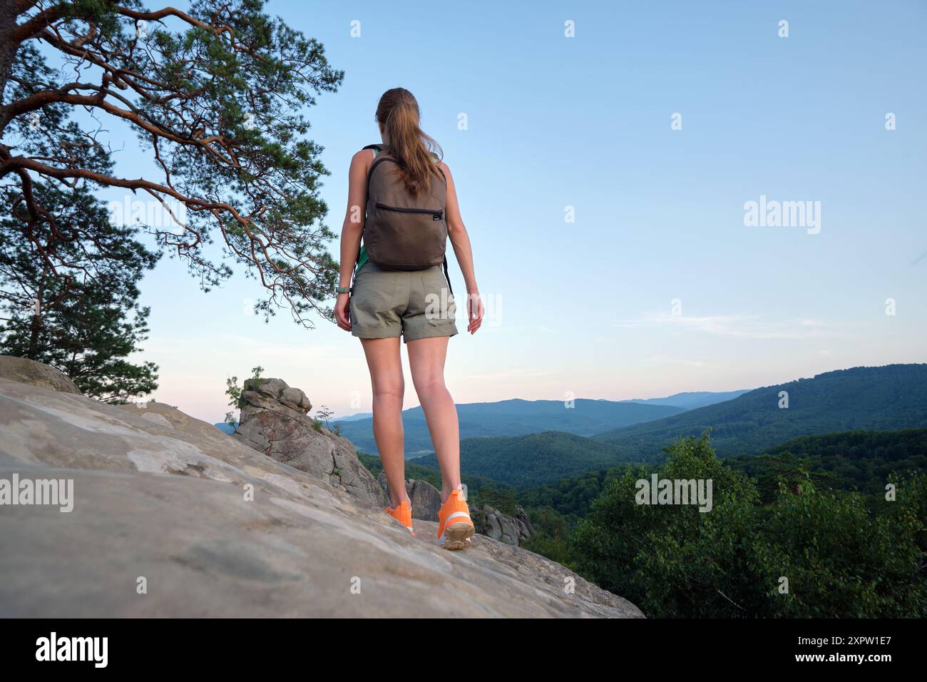 Hiker woman clambering on rocky mountain footpath in nature. Lonely ...