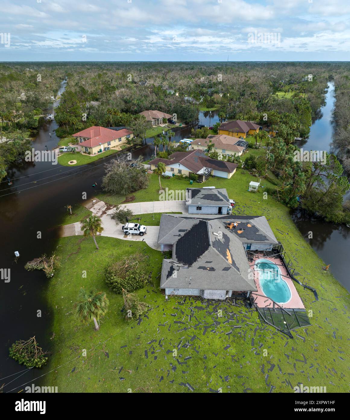 Hurricane Ian destroyed house with damaged roof and lanai enclosure ...