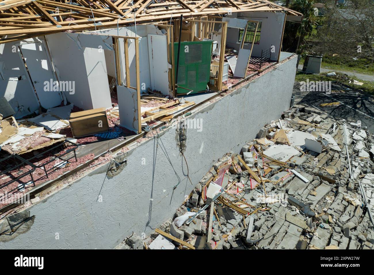 Ruined building in need of repair. Wind damaged house roof with missing ...