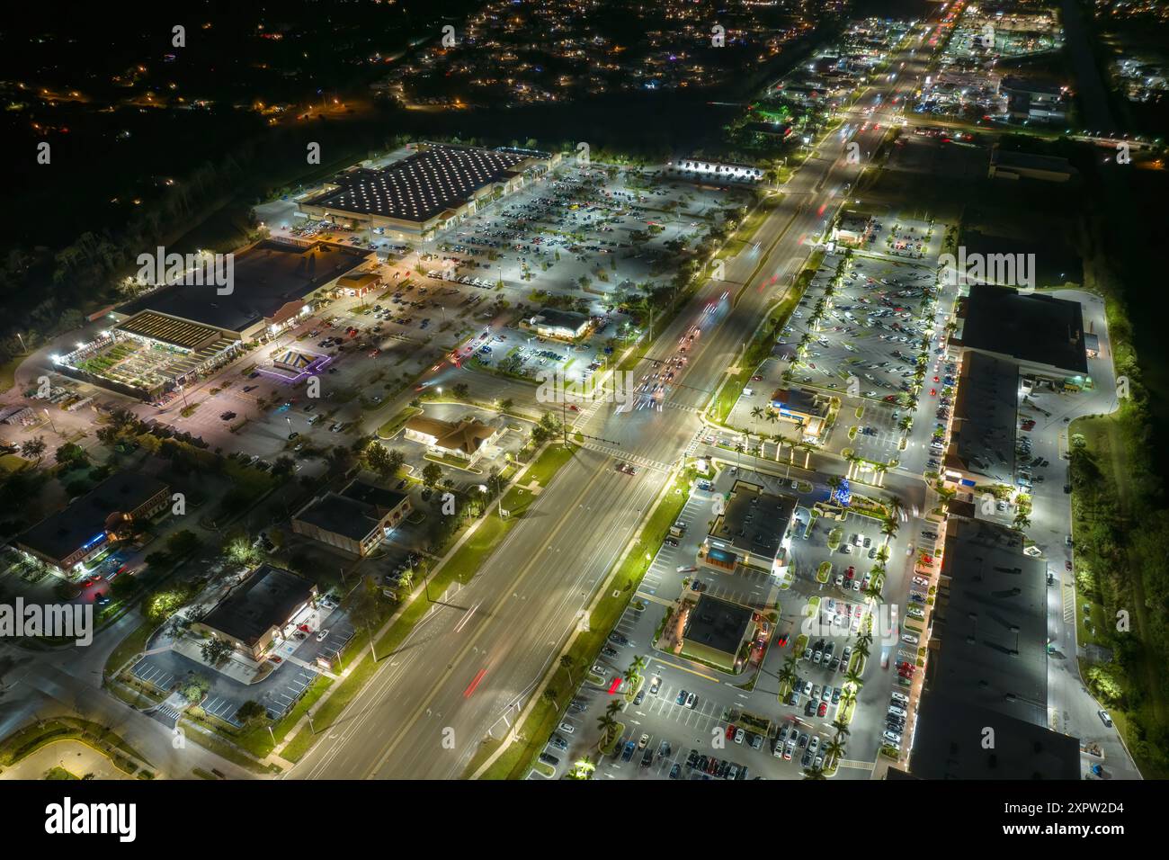Shopping plaza stores and malls at sunset and American wide highway ...