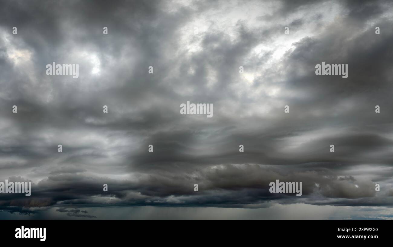 Stormy cumulonimbus clouds forming before thunderstorm on dark sky. Moving and changing ...
