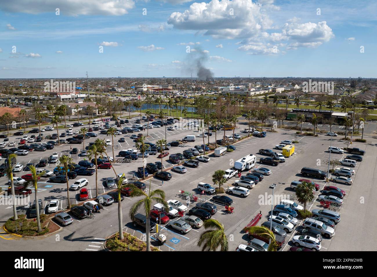 Top view of many cars parked on a parking lot in front of a shopping ...