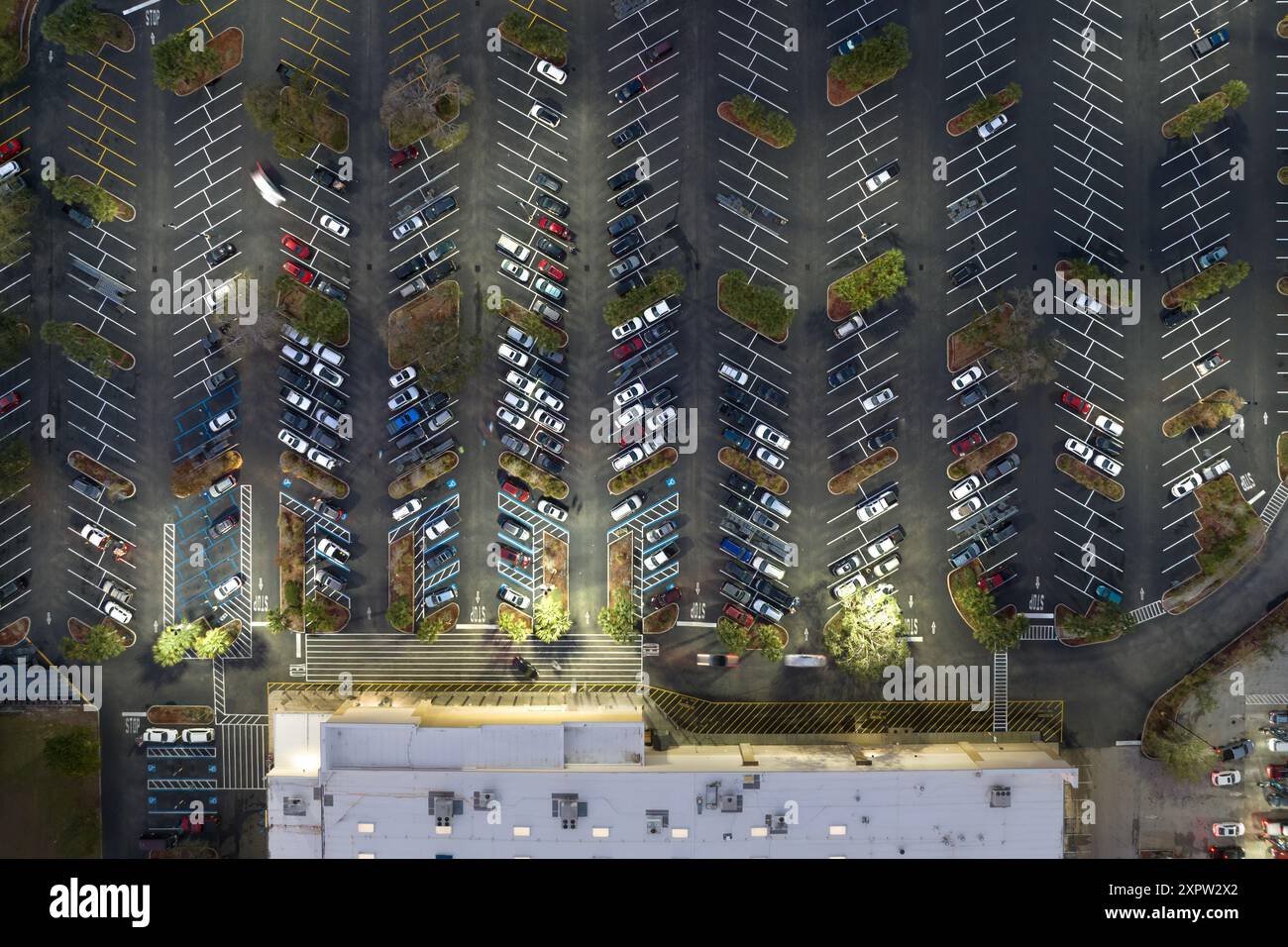 Top view of many cars parked on a parking lot in front of a shopping ...