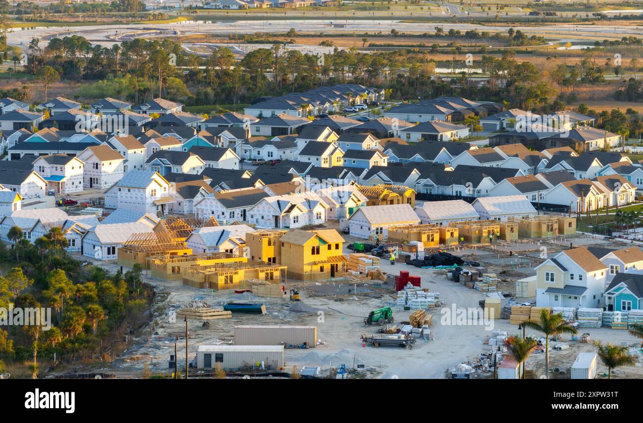 Unfinished frames of inexpensive homes with wooden roof beams under ...