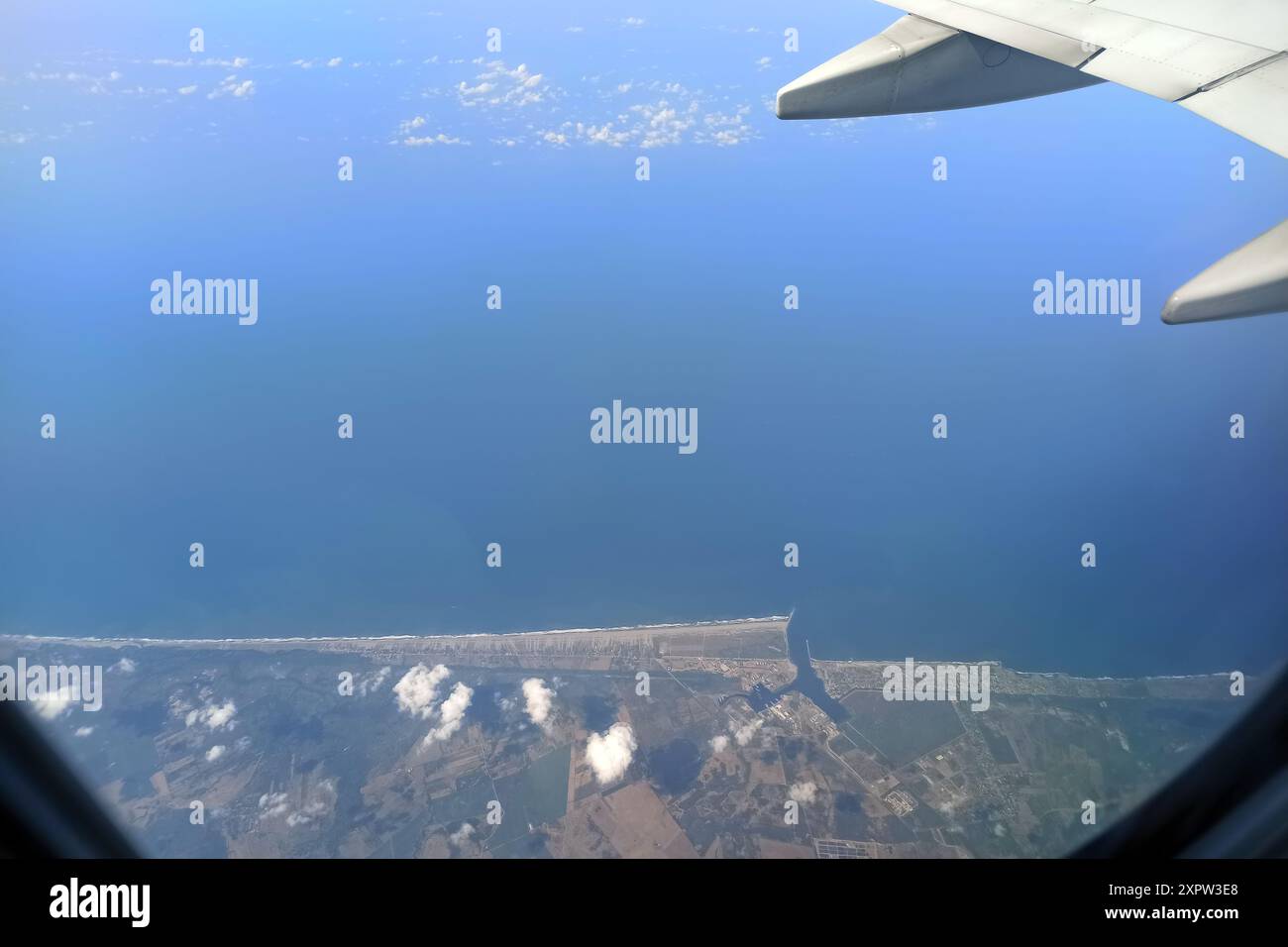 View through airplane window of commercial jet plane wing flying high ...