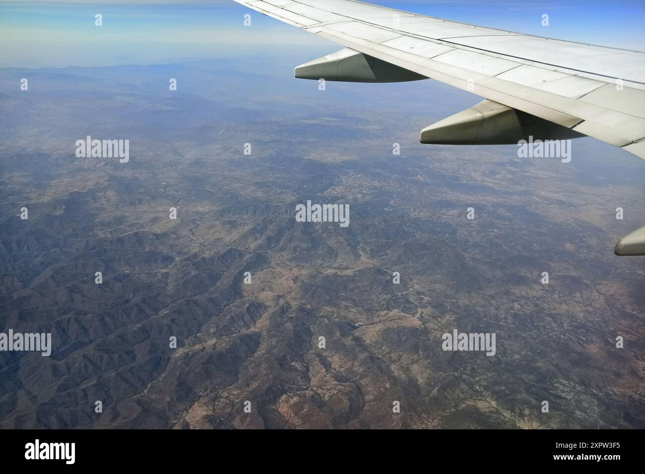 View through airplane window of commercial jet plane wing flying high ...