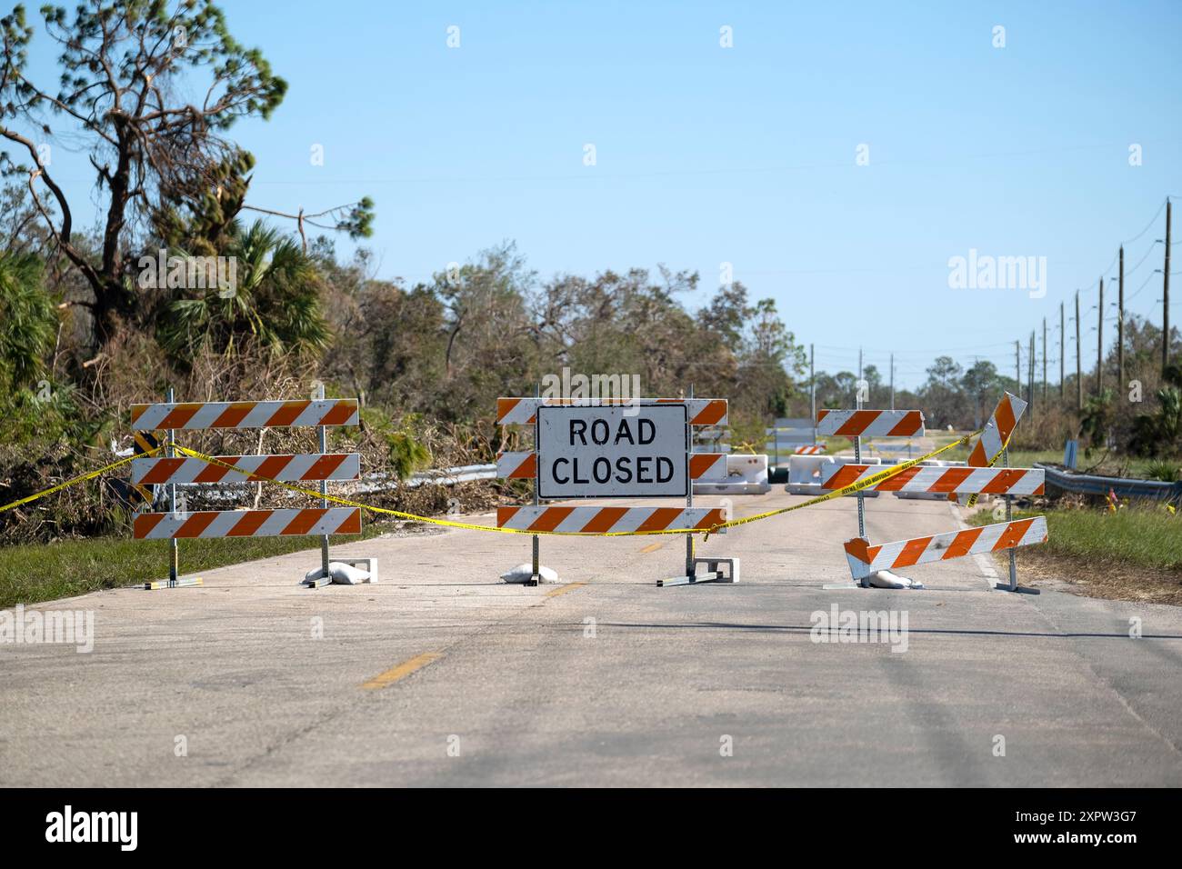 Warning roadworks sign and safety barrier on city street during ...