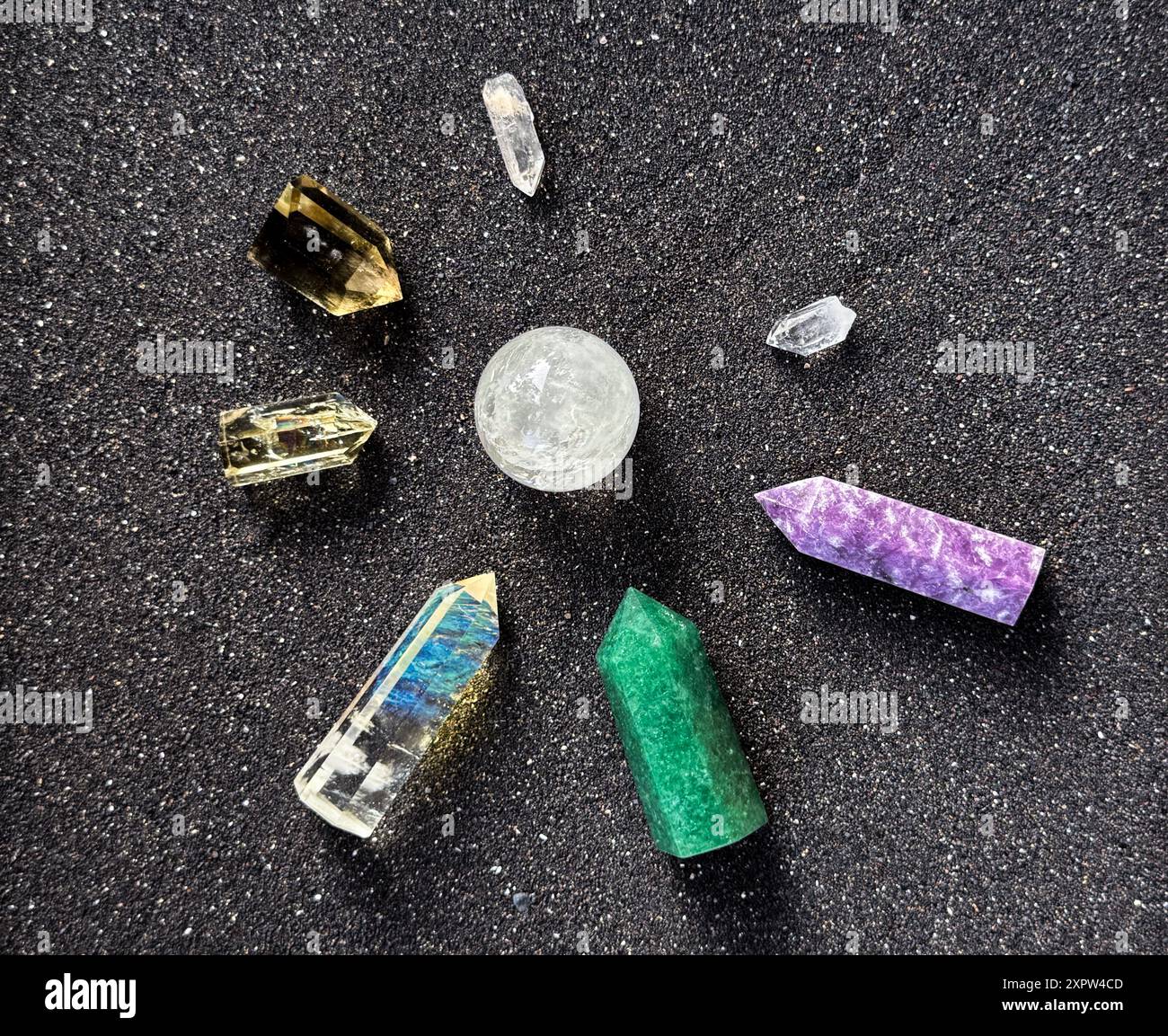 Colorful Crystals and Gemstones Arranged on Black Sand Background in ...
