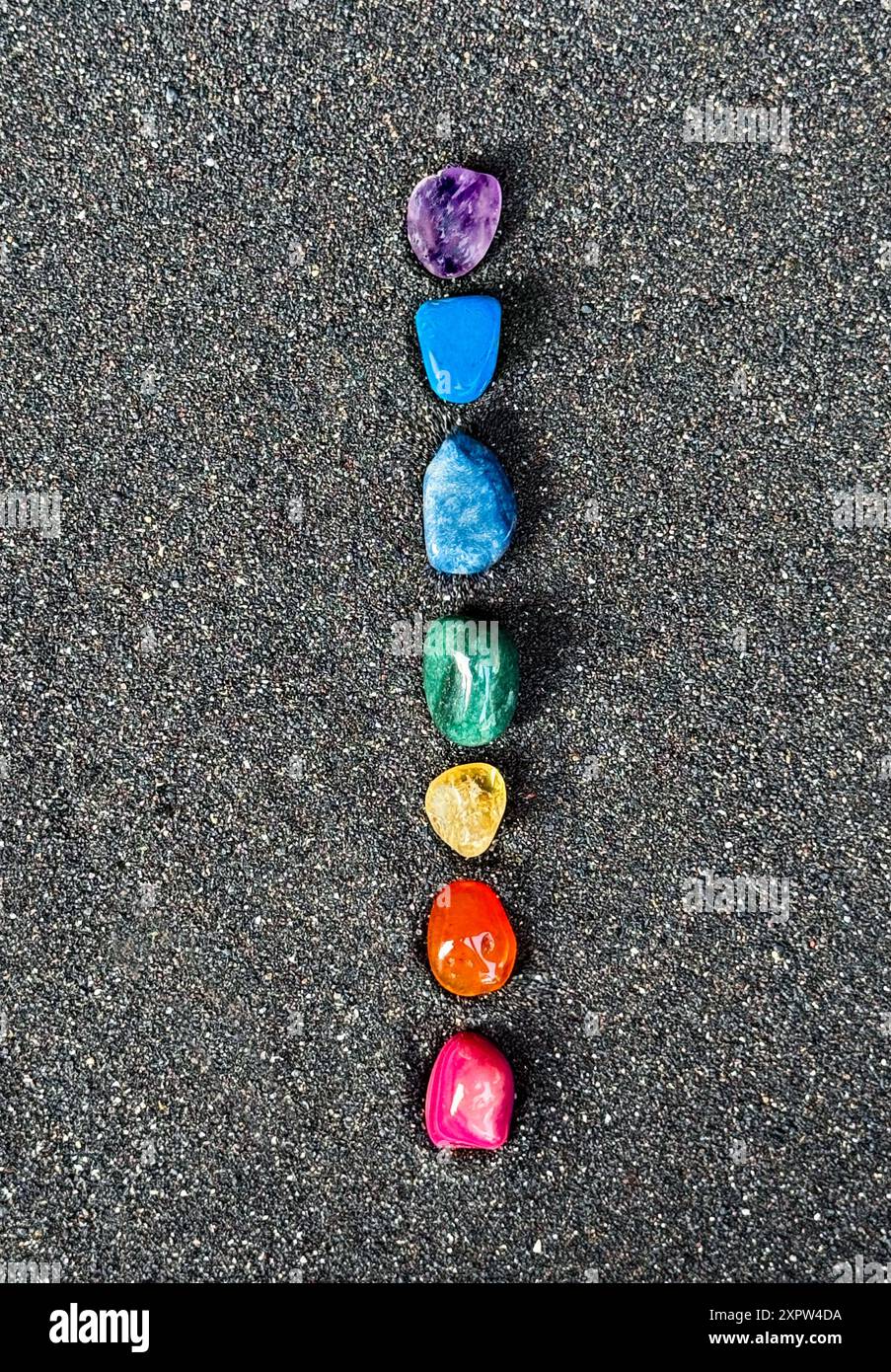 Colorful Healing Crystals Aligned on Black Sand Background Stock Photo ...