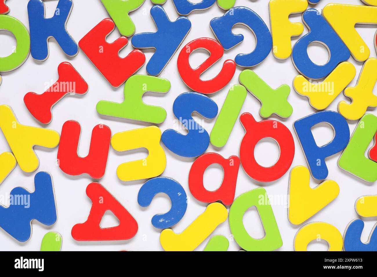 Alphabet. Many colorful magnetic letters on white background, flat lay ...